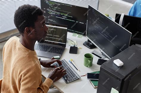 Premium Photo Serious African American Developer Working With Security Codes On Computer At