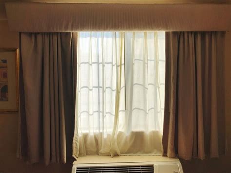 Premium Photo Clothes Hanging On Window Sill At Home