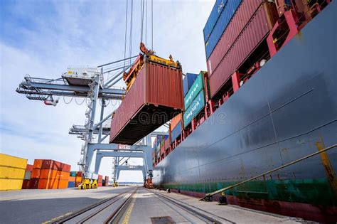 Loading Containers In Cargo Freight Ship With Industrial Crane