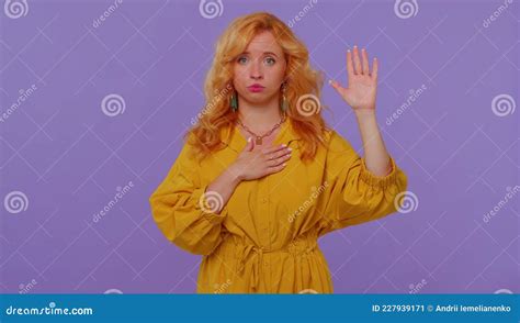 Sincere Responsible Redhead Girl Raising Hand To Take Oath Promising To Be Honest And To Tell