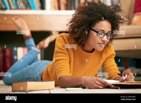 Shes Enjoying Her Required Reading Full Length Shot Of A Young Woman