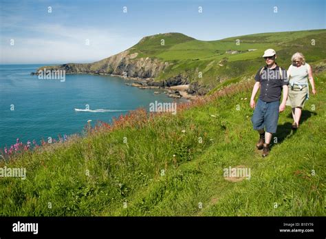 Two People Walking The Cardigan Bay Coastal Path Between Llangrannog