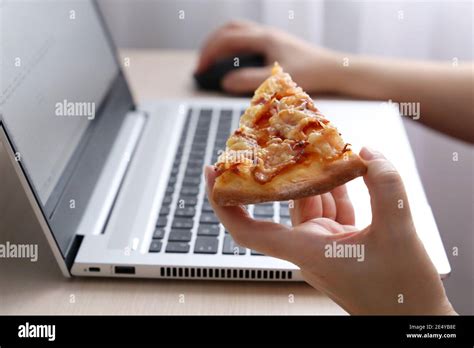 Girl Eating Pizza During Work At Laptop Female Hand Close Up Snack In