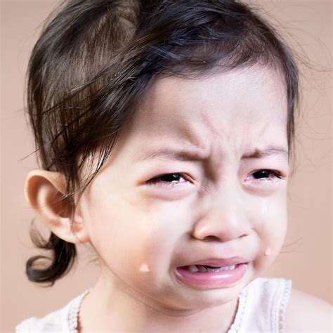 Premium Photo Close Up Of Innocent Girl Crying Against Beige Background