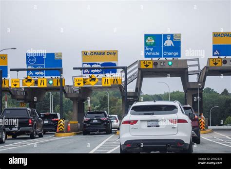 A Car Enters A Toll Plaza Macpass Banner At A Toll Plaza Mac Pass Is