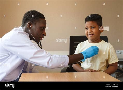African American Man Pediatrician Doctor Using Stethoscope To Examining