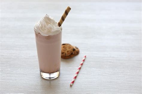 Premium Photo Delicious Milkshake With Cookies On Wooden Table