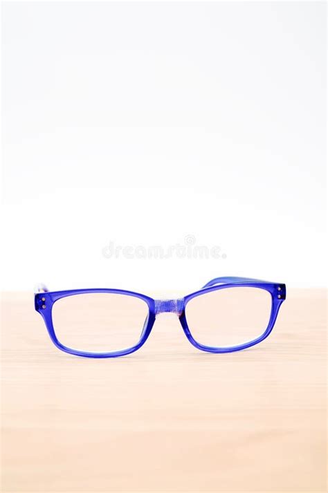 Broken Blue Plastic Eye Glasses With Adhesive Tape Isolated On A