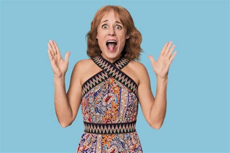 Premium Photo Redhead Midaged Caucasian Woman In Studio Celebrating A Victory Or Success