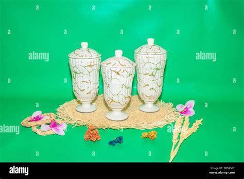The Set Of Three White Ceramic Canisters Is A Stylish And Practical