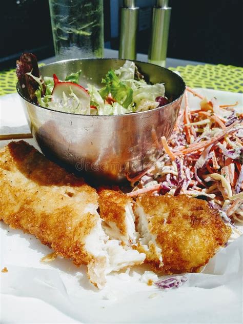 Deep Fried Cod Fish With Coleslaw And Green Salad On The Side Stock