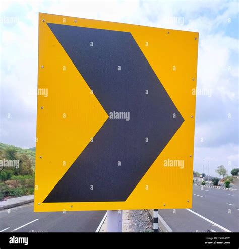A Black And Yellow Chevron Sign Warning About Dangerous Curves Medians