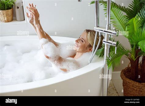 Cheerful Attractive Happy Young Female Soaping And Foaming Herself In