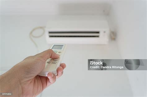 리모컨을 들고 벽에 걸린 흐릿한 에어컨을 가리키고 있는 손 온도 또는 설정 개념 조정 겨냥에 대한 스톡 사진 및 기타 이미지 겨냥 공기조화 교류 Istock