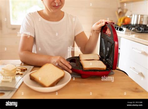 A Woman Is Going To Make Toast In The Toaster Oven In The Kitchen Stock Photo Alamy