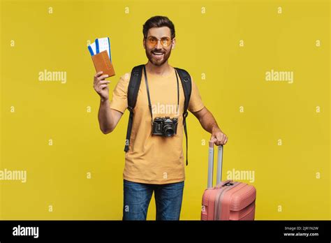 Happy Middle Aged Man Holding Passport And Tickets Standing With
