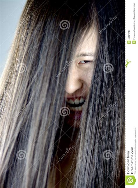 Shouting Asian Female Monster With Long Hair On Face Stock Image