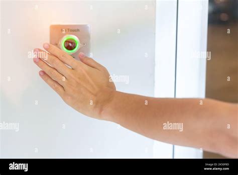 Hand Open The Door By No Touch Sensor Switch On The Wall At Office Or