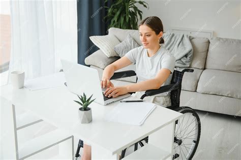 Premium Photo Female Freelance Programmer Sitting In Wheelchair And Using Computers While