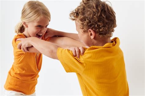 Premium Photo Sibling Fighting Against White Background