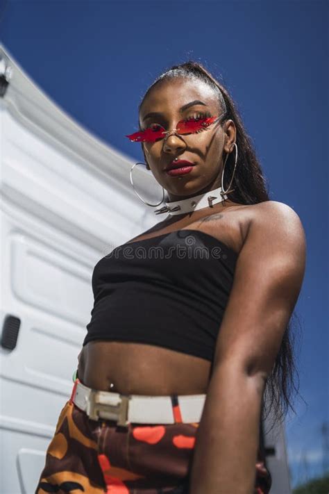 African Female With Long Hair Wearing A Crop Top And Red Camouflage