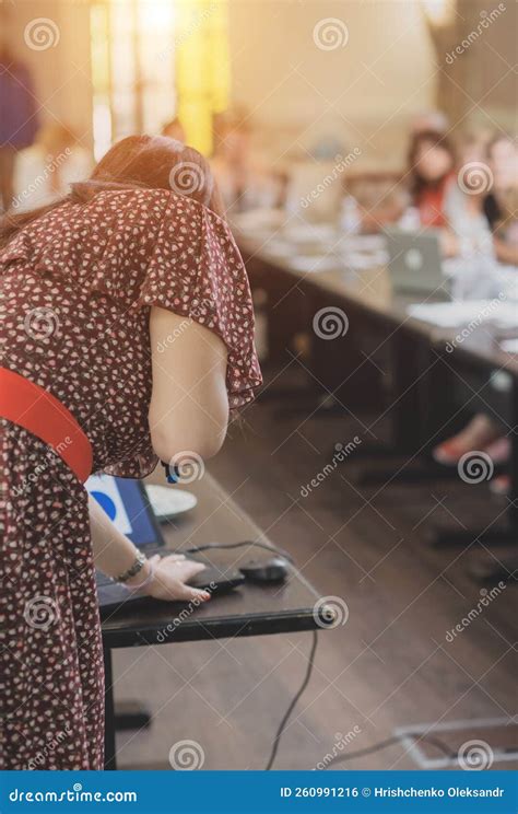 The Girl Controls The Laptop And The Projector At The Presentation