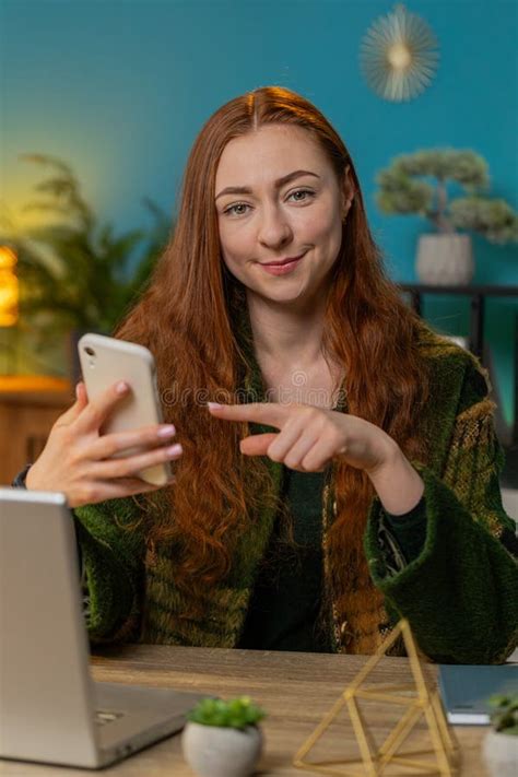 Smiling Young Businessman Using Smartphone Online Application Pointing