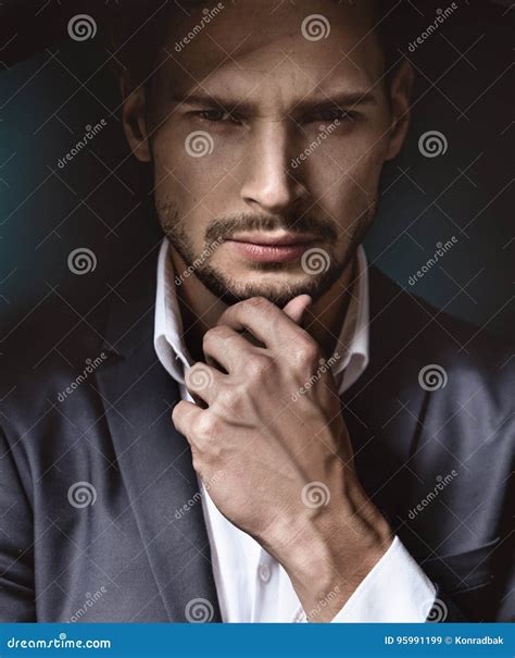 Portrait Of Handsome African American Male Body Builder With Naked Torso Posing On A Black