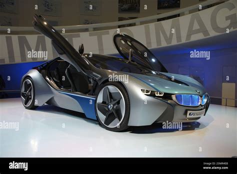 A White Bmw I8 Concept Car With Butterfly Doors Open Is On Display In