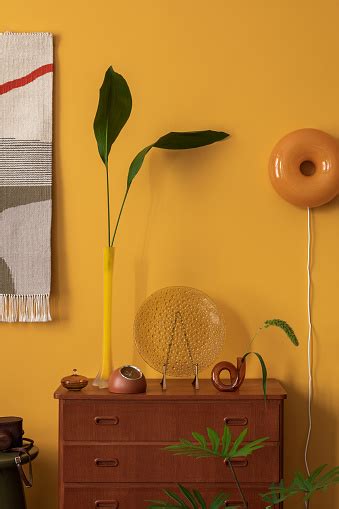 킬림 러그 나무 찬장 나뭇잎이 있는 노란색 꽃병 시계 식물 원형 램프 및 개인 액세서리가 있는 빈티지 거실 인테리어의 미니멀한 구성 가정 장식 템플렛 0명에 대한 스톡 사진