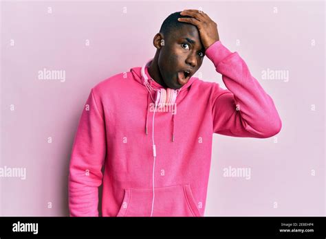 Young African American Man Wearing Gym Clothes And Using Headphones
