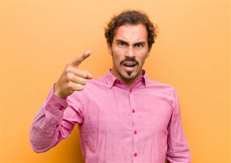Premium Photo Pointing At Front With An Angry Aggressive Expression