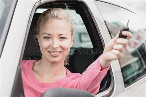 Portrait Of Responsible Female Driver Holding Car Keys In Her Hand Safe And Responsible Driving