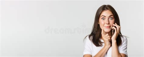 Close Up Of Intrigued Smiling Girl Talking On Smartphone With Tempted