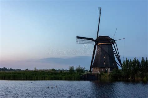 Beautiful Wooden Windmills At Sunset In The Dutch Village Of Kinderdijk