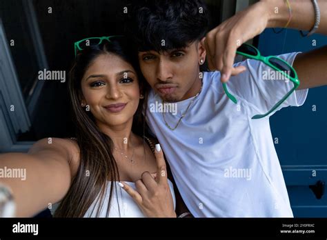 Beautiful Young Teenage Couple With Funny Faces Having Fun Taking A