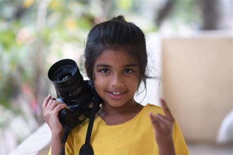 Premium Photo Portrait Of Smiling Girl Holding Camera