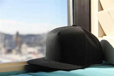 A Black Hat Sitting On Top Of A Window Sill Photo Free Wallpaper