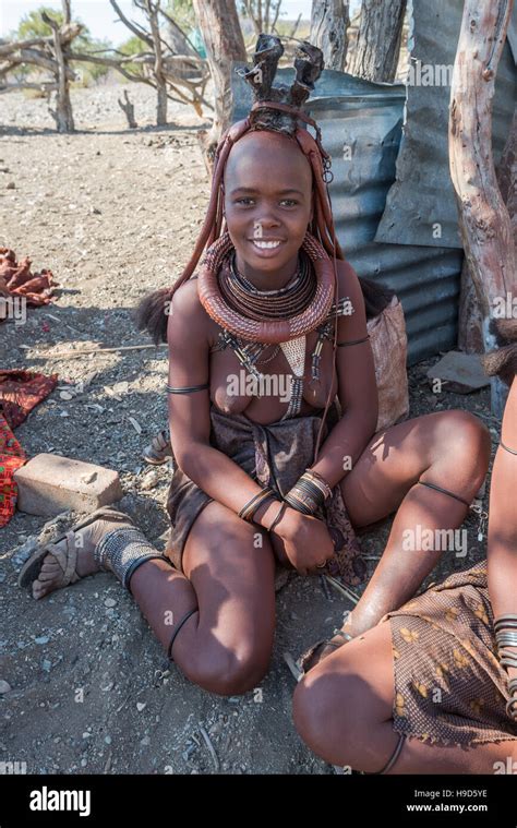 A Young Girl In Traditional Clothes And Decoration From Himba People Is