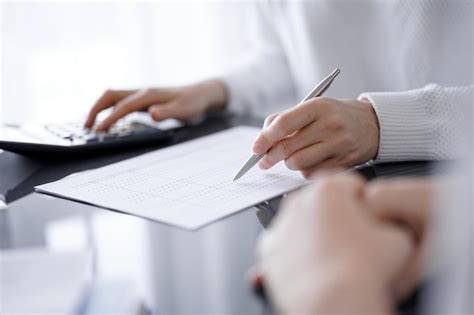 Premium Photo Woman Accountant Using A Calculator And Laptop Computer