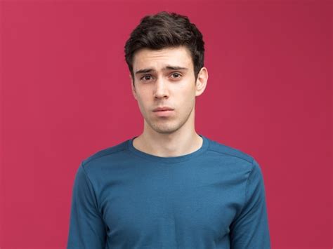 Free Photo Clueless Young Brunette Caucasian Boy Looking At Camera On