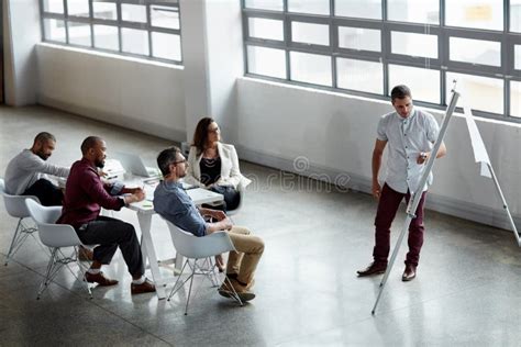 Presenting His Proposal High Angle Shot Of A Group Of Businesspeople Meeting In The Boardroom