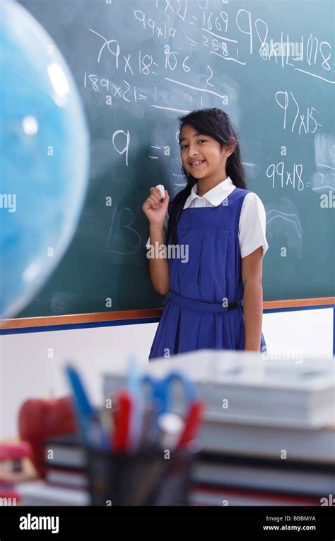 Girl At Chalkboard Smiling Stock Photo Alamy