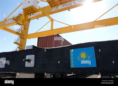 Unloading Containers At The Logistics Center Machines And Cranes Drag