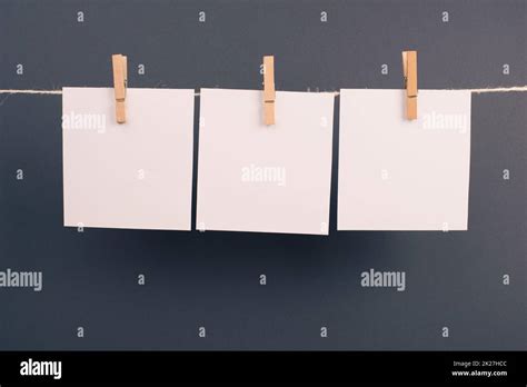 Empty White Sheets Of Paper In A Row Hanging On A String Copy Space