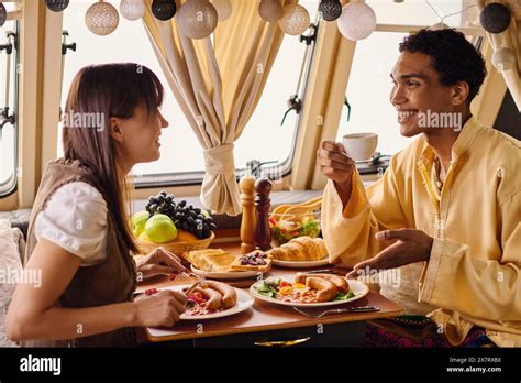 An Interracial Couple Enjoying A Delicious Lunch In Their Camper Van Stock Photo Alamy
