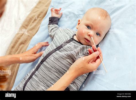 Mother Cleaning Nose To Adorable Baby Stock Photo Alamy
