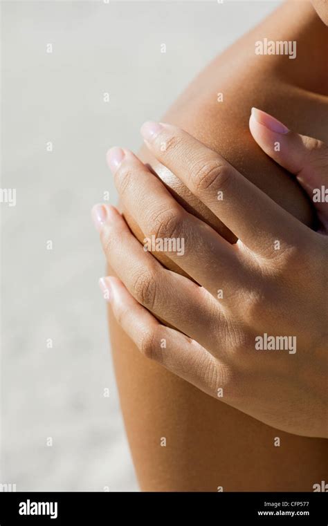 Woman S Hand On Bare Shoulder Cropped Stock Photo Alamy