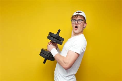 Premium Photo Young Surprised Nerd Guy In Glasses Holds Heavy