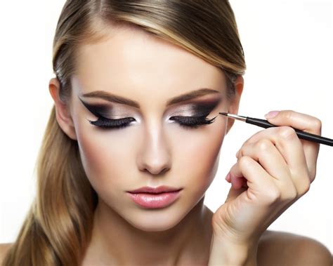 A Young Beautiful Lady Doing Makeup With A Bold Winged Eyeliner To
